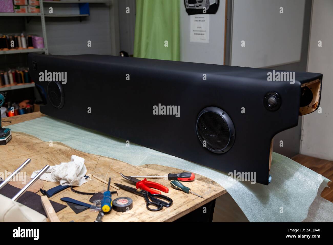 A box made of wood and sawn holes with black leather for the ...