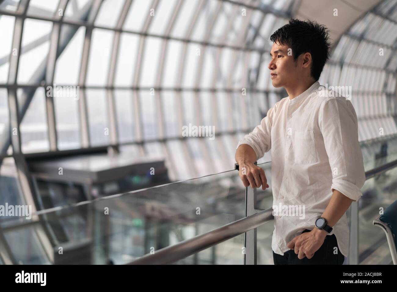 Asian man airport luggage hi-res stock photography and images - Alamy