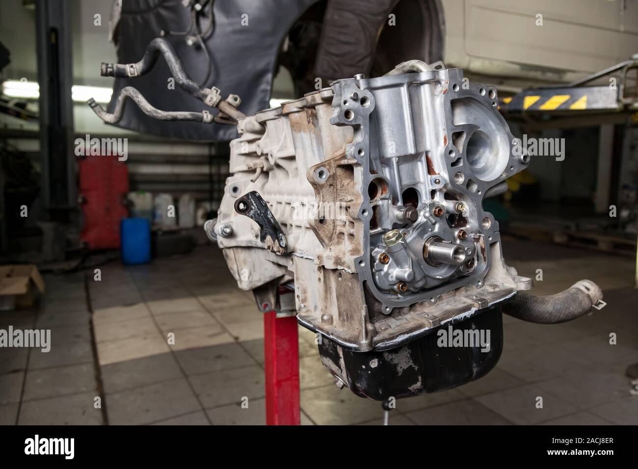 A car raised on a rotary lift for overhaul repair and under it a ...
