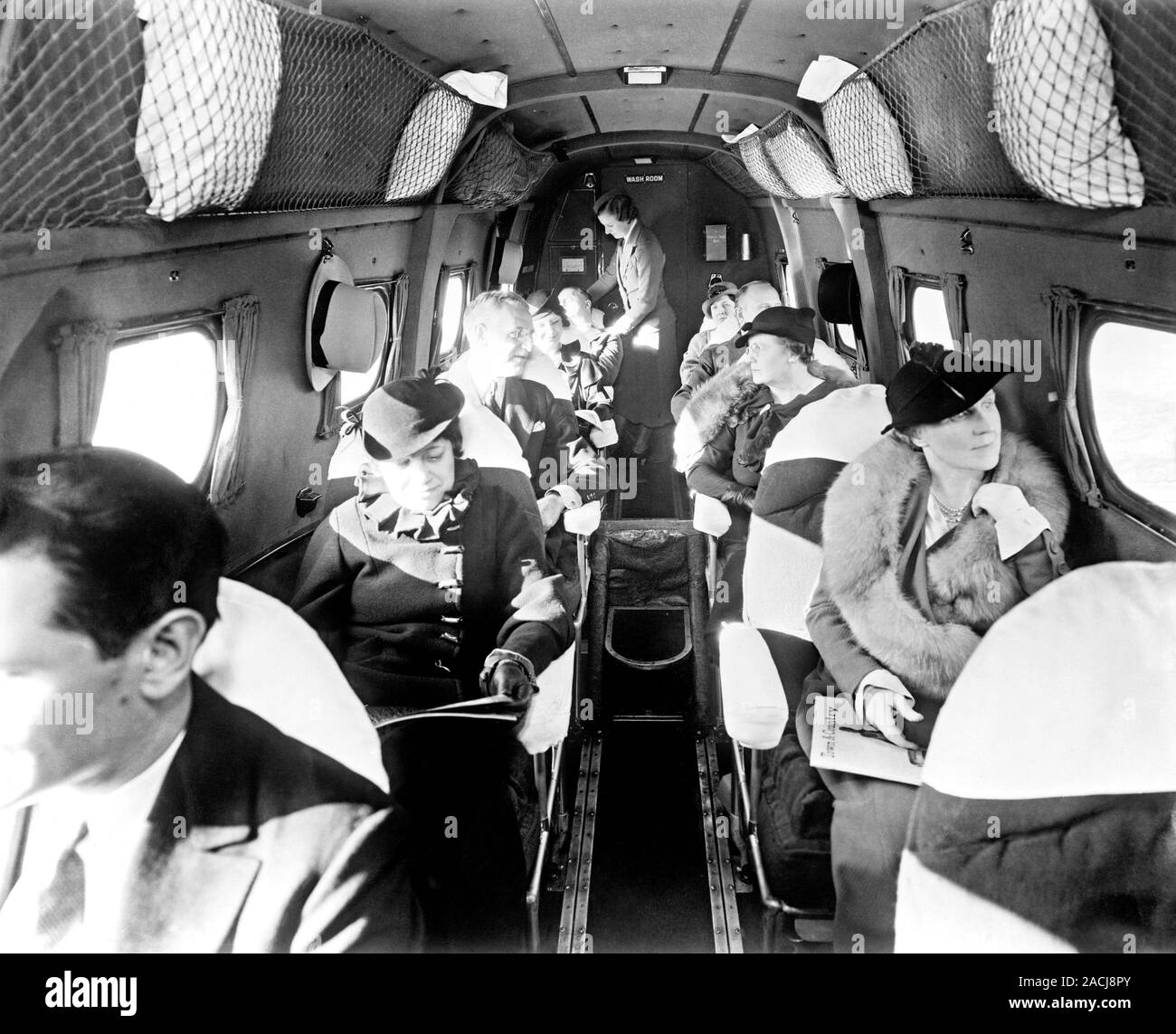 Early commercial aviation. View down the gangway of a small passenger ...