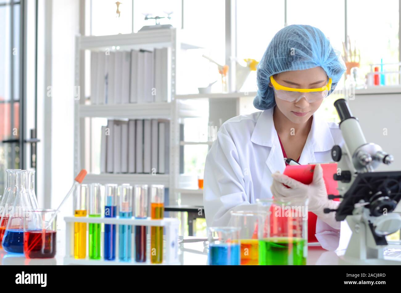 The woman scientist in laboratory doing experiments with chemical ...
