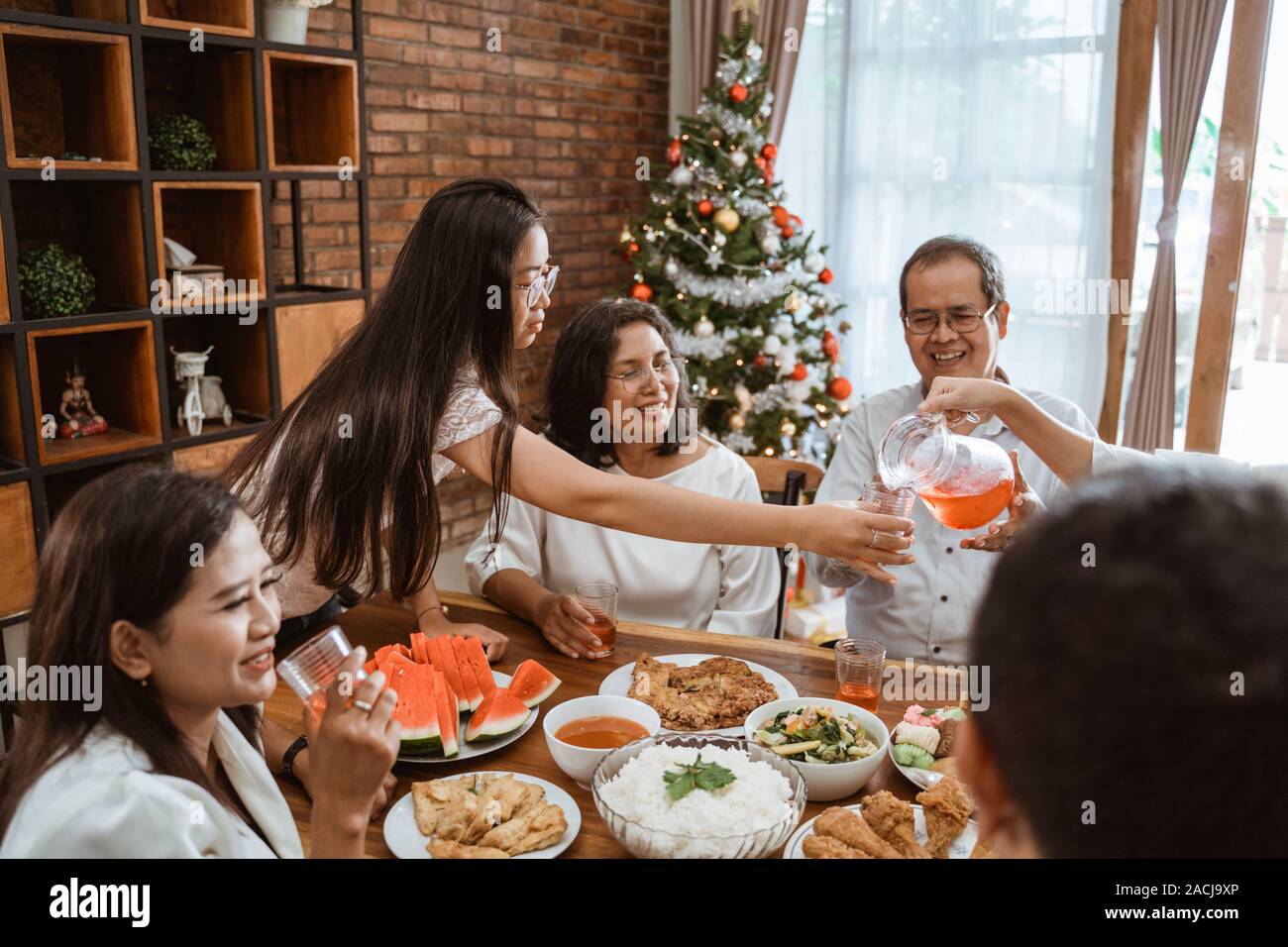 Cheerful family at dining table for christmas dinner in the house Stock ...