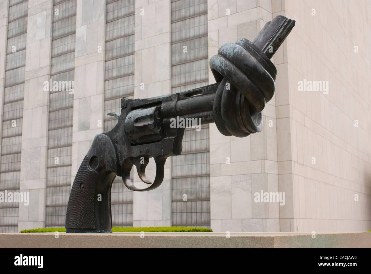 A sculpture depicting a revolver with a knot in its barrel on display ...