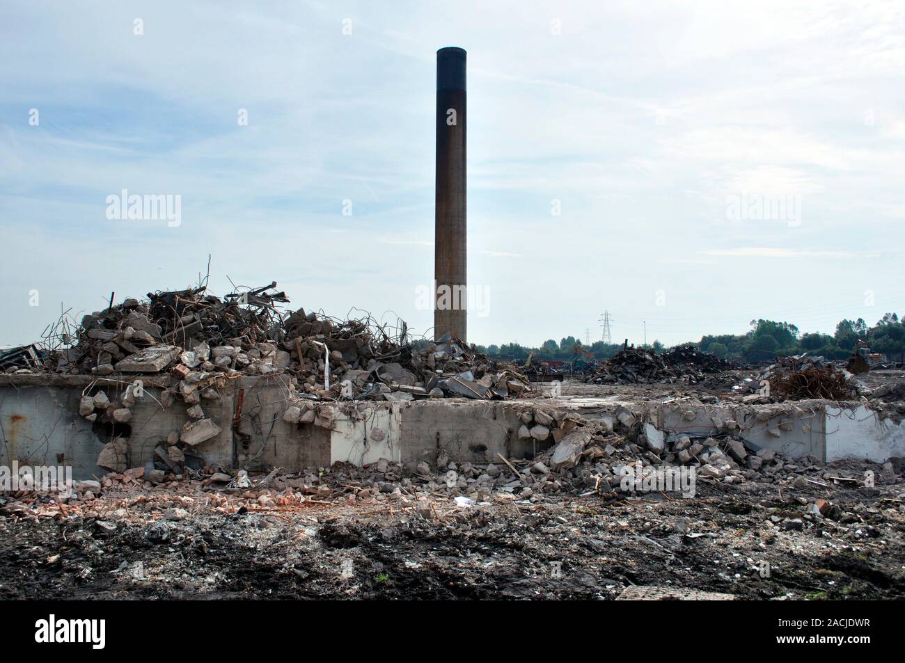 Chemical factory demolition. Rubble and lone chimney stack during the ...
