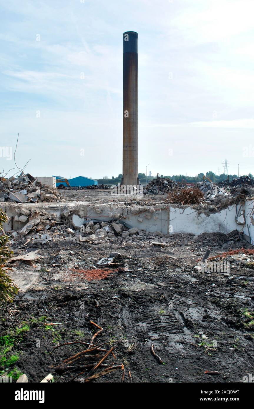 Chemical factory demolition. Rubble and lone chimney stack during the ...
