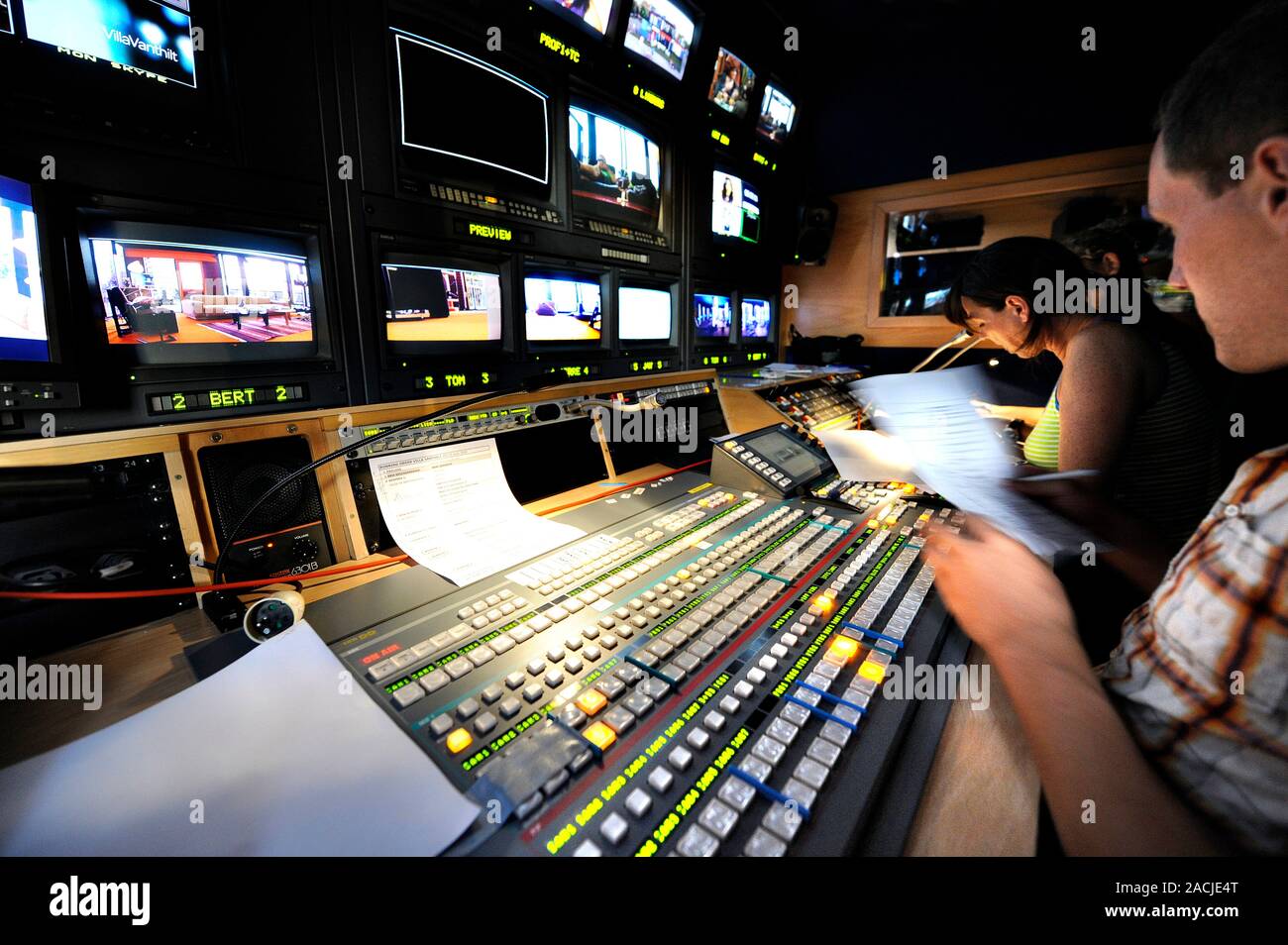 Television control room. Technicians operating control panels in a ...