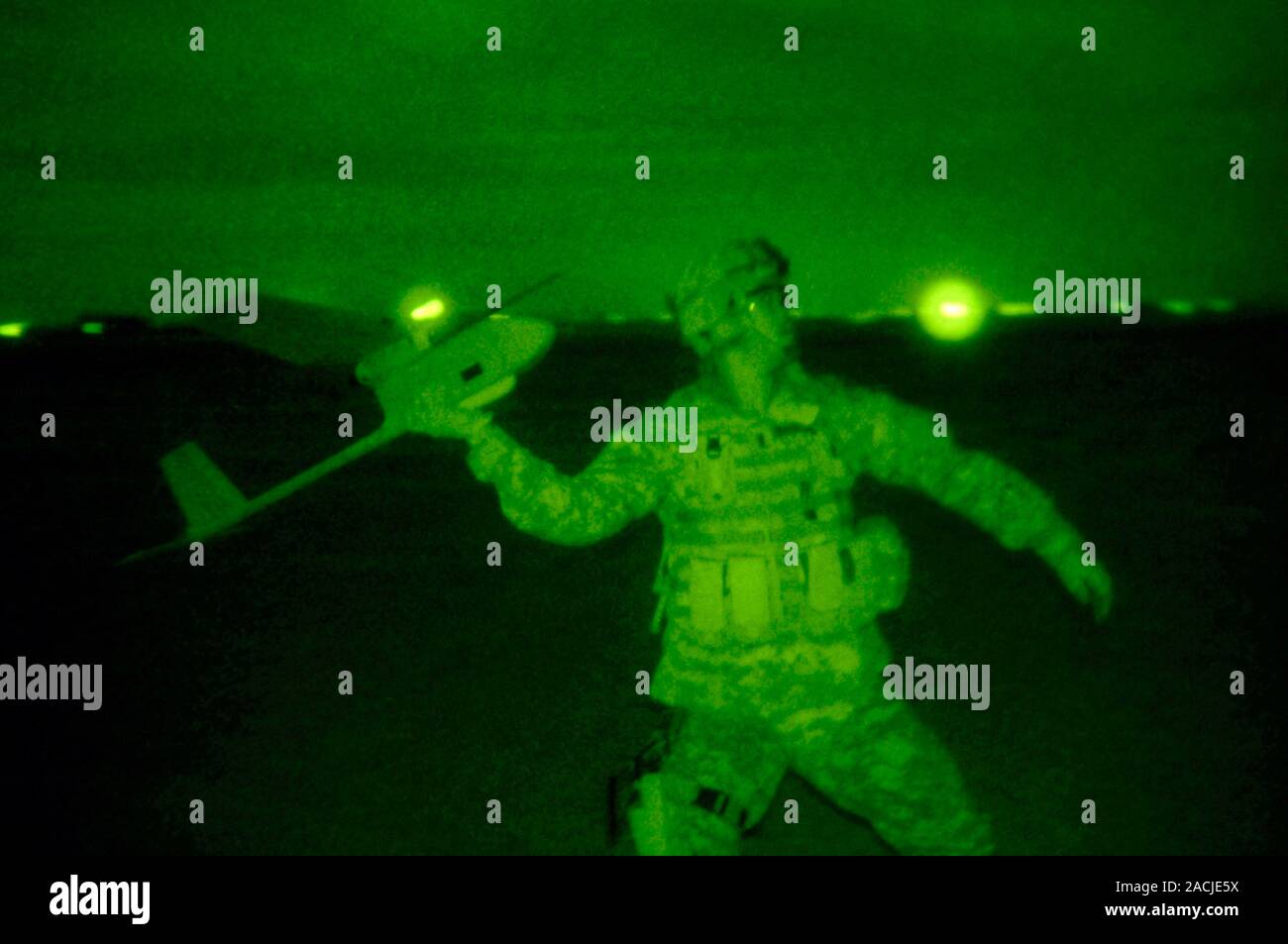 Raven UAV, night launch. US Army soldier preparing to launch the Raven ...