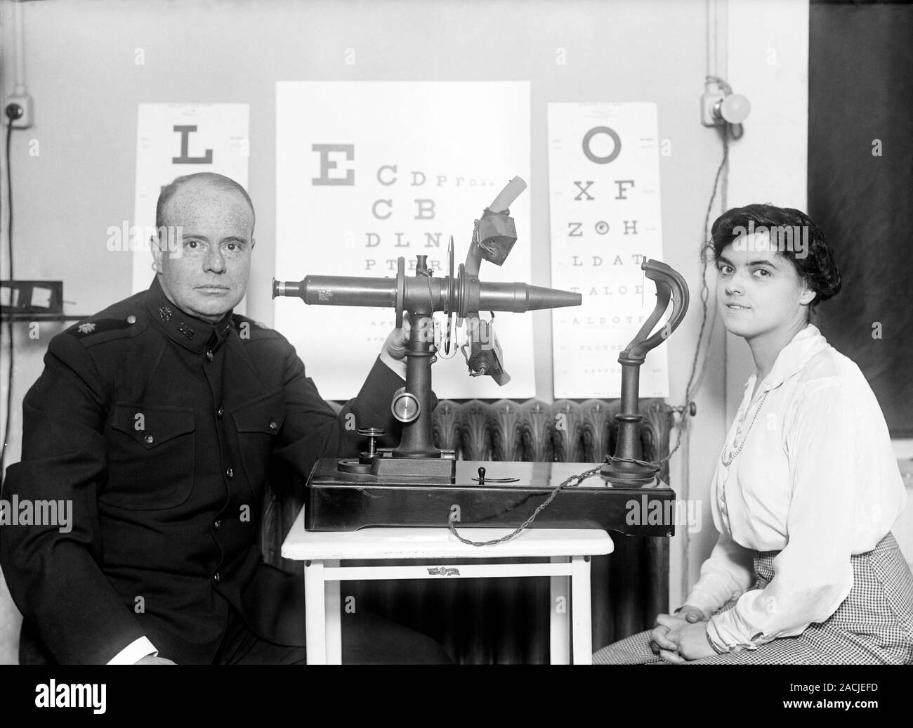Early 20th Century eye examination. Historical image of a woman with an ...