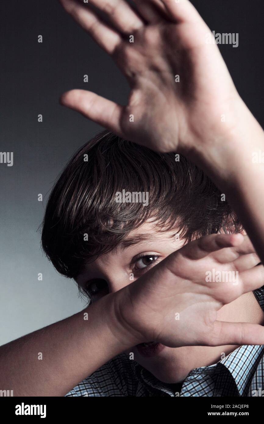 Scared young man defending himself Stock Photo - Alamy