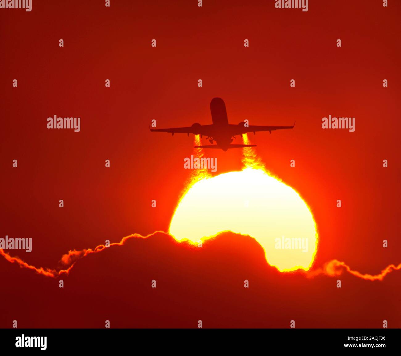 Boeing 737 taking off at sunset. The orange plumes behind the aircraft ...