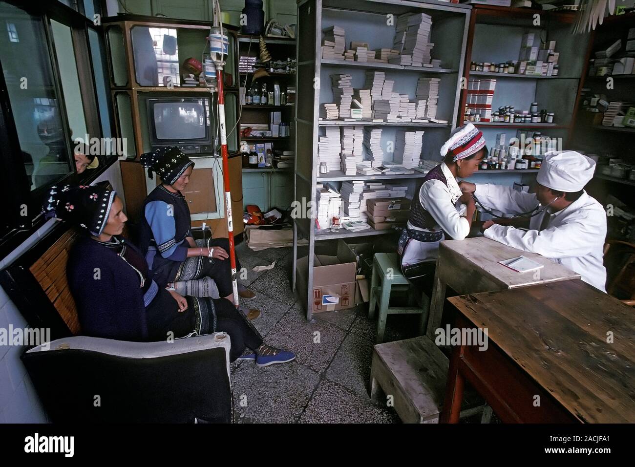 Bai medical clinic, China. Bai women being seen by a doctor at a ...