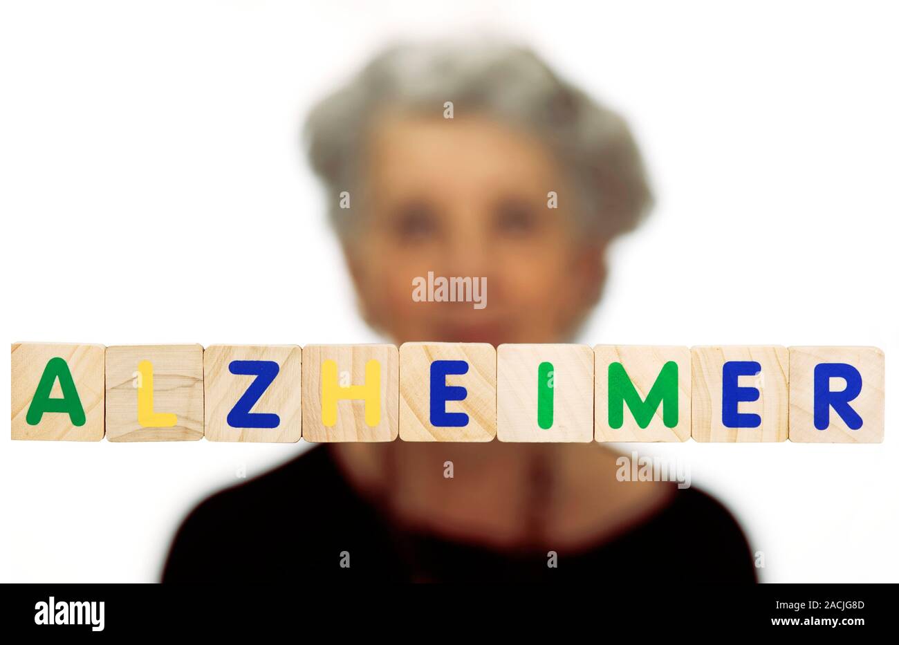 Alzheimer's disease, conceptual image. Elderly women behind letters ...