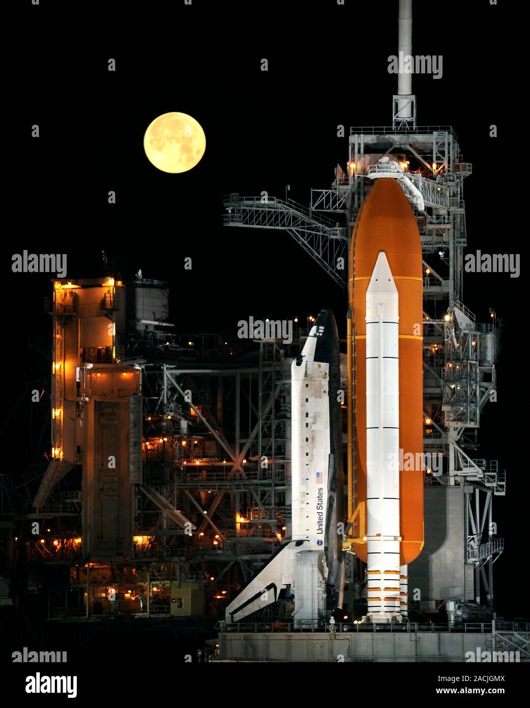 Space shuttle on launchpad at night. Space shuttle Discovery sitting ...