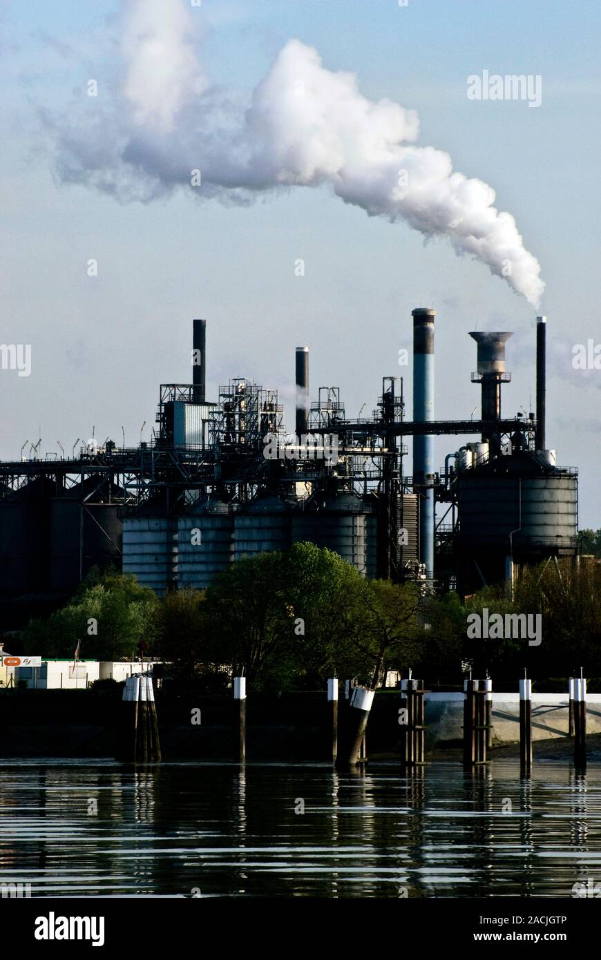 Oil refinery. Petrochemical plant by a river. Photographed in Normandy ...