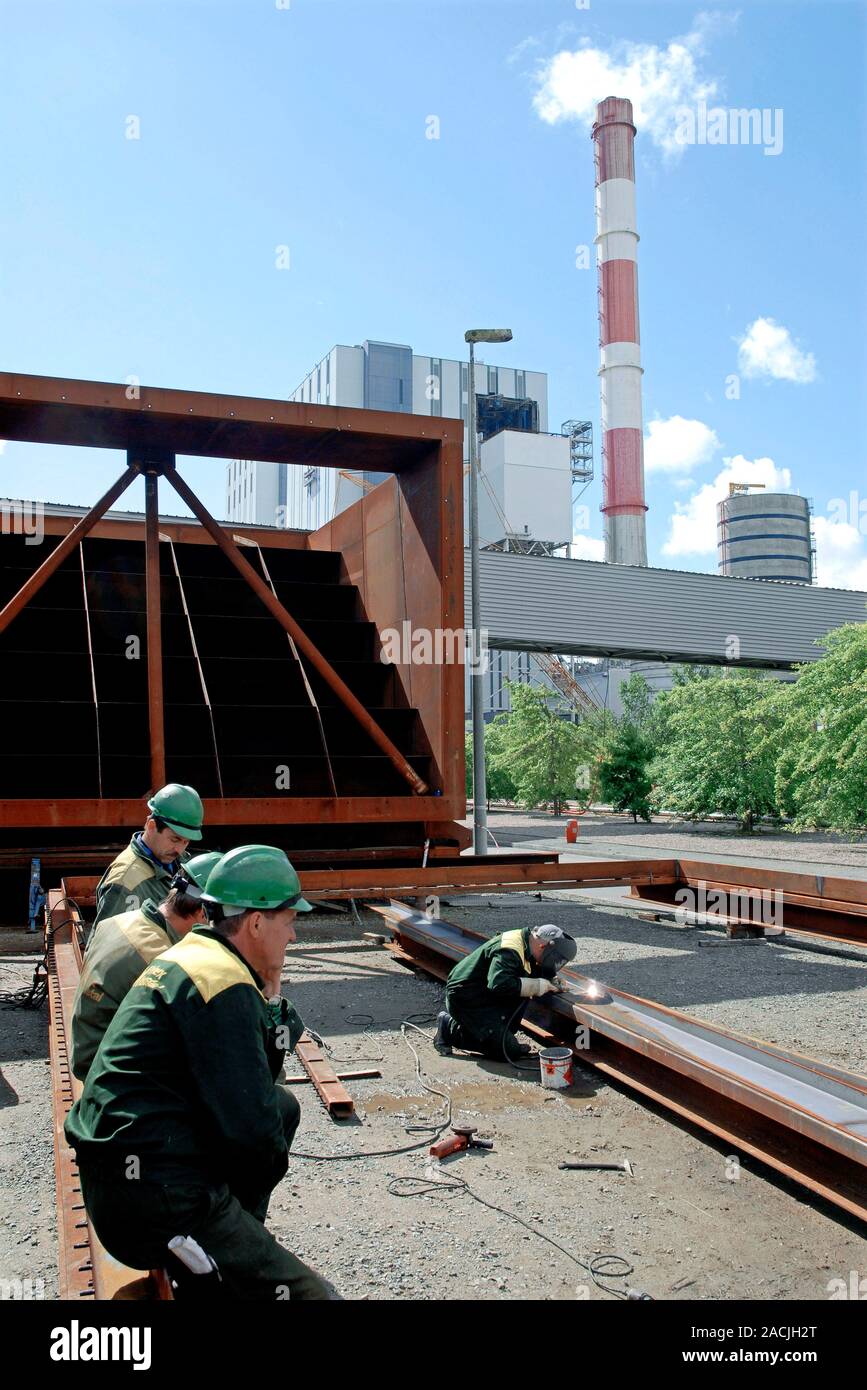 Flue gas desulphurisation plant. Workers building part of the flue gas ...