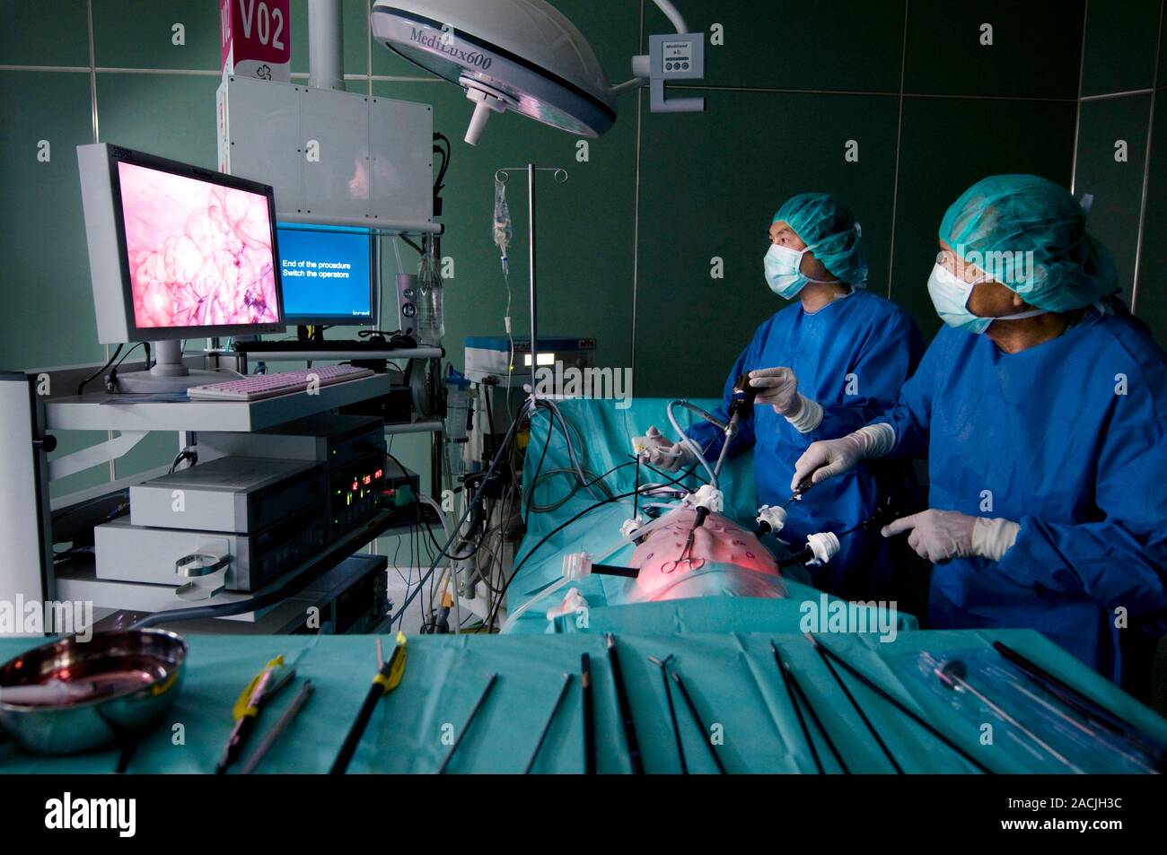 Keyhole surgery training centre. Surgeon (right) demonstrating ...