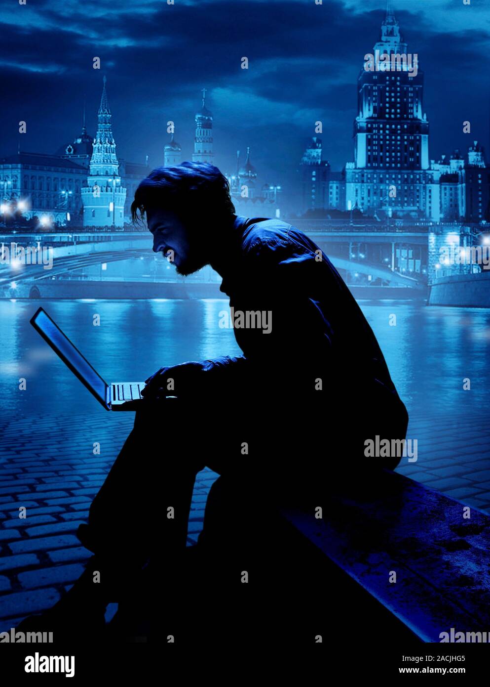 Computer hacker, artwork. Man sitting on a bench with a wireless laptop ...