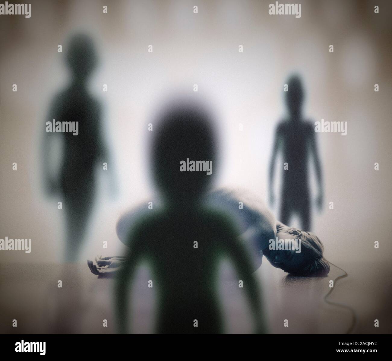 Alien abduction. Comatose human female surrounded by shadowy humanoid ...
