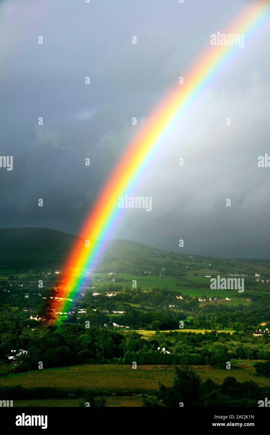 Rainbow over fields Stock Photo - Alamy