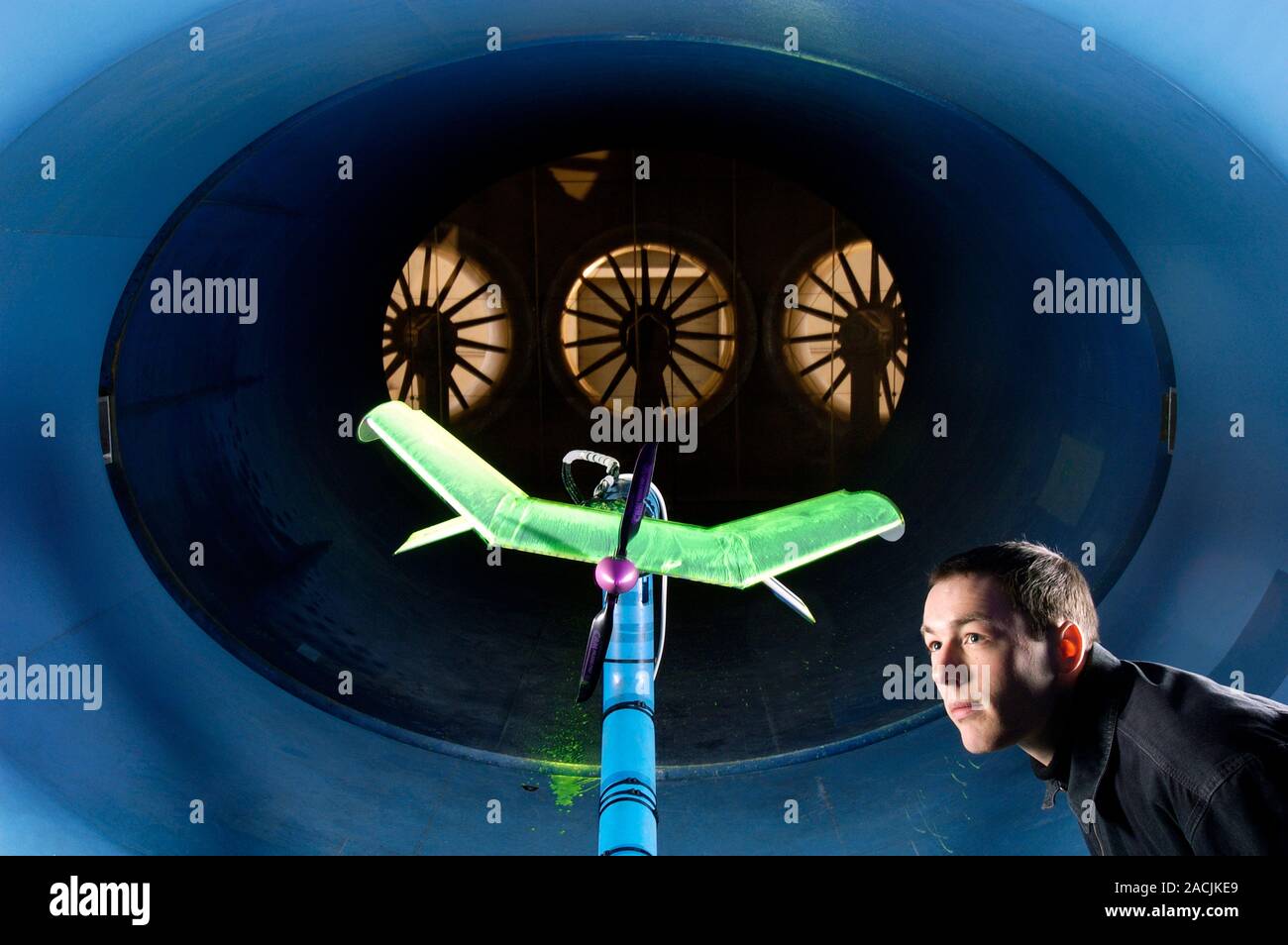 Unmanned aerial vehicle development. Researcher supervising wind tunnel ...