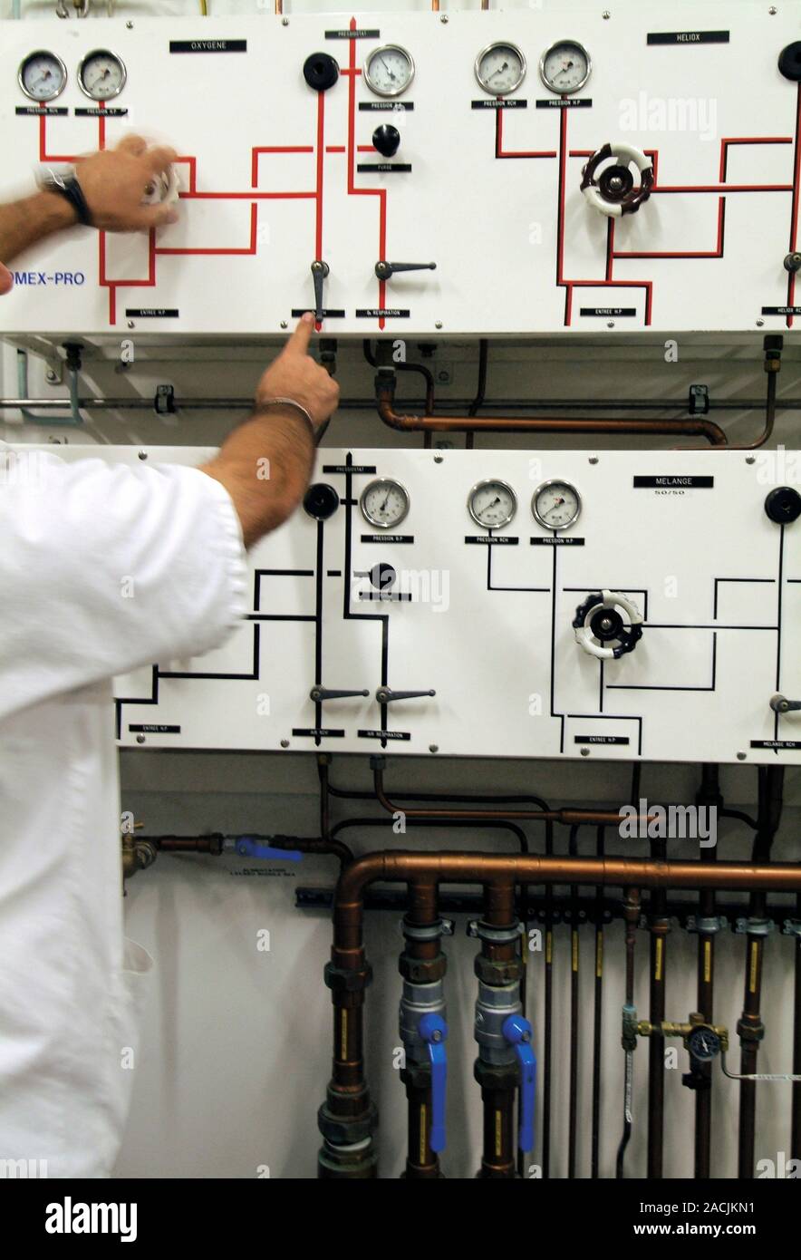 Hyperbaric chamber in a hospital. Technician at the control panel of a ...