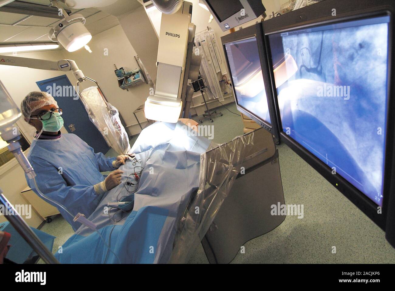 Coronary angiography. Doctor performing an angiogram of the blood ...