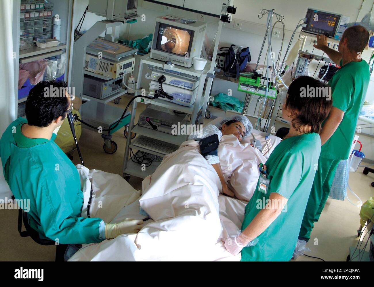 Colonoscopy examination. Doctor performing a colonoscopy on a patient ...