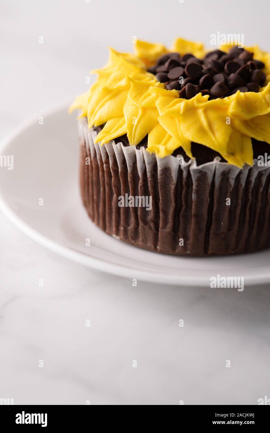 Beautiful sunflower decorated chocolate cupcake on marble table Stock ...
