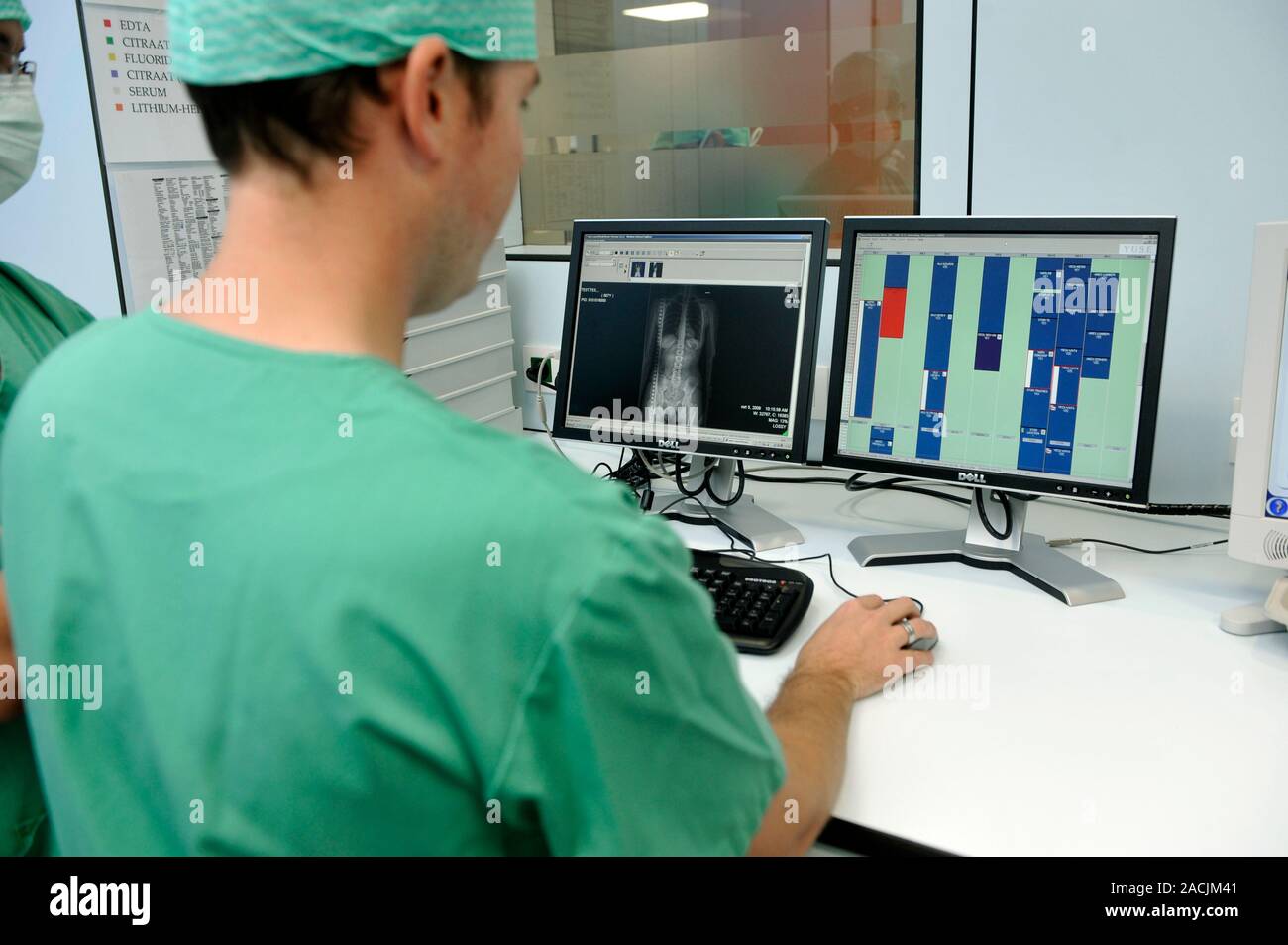 Doctors working on a computer. Surgical staff in their scrubs, working ...