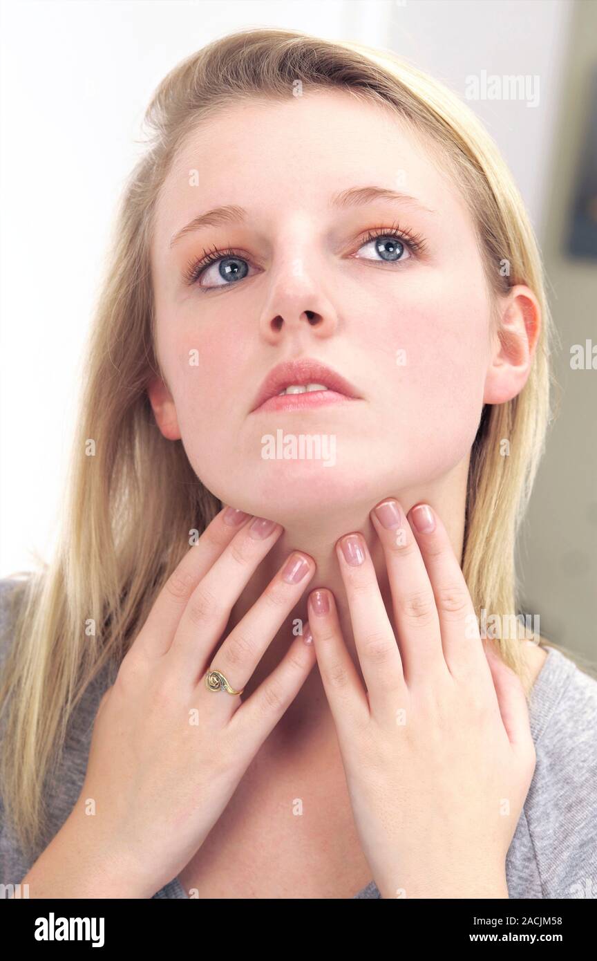 Throat pain. Young woman touching her painful throat. This may be a ...