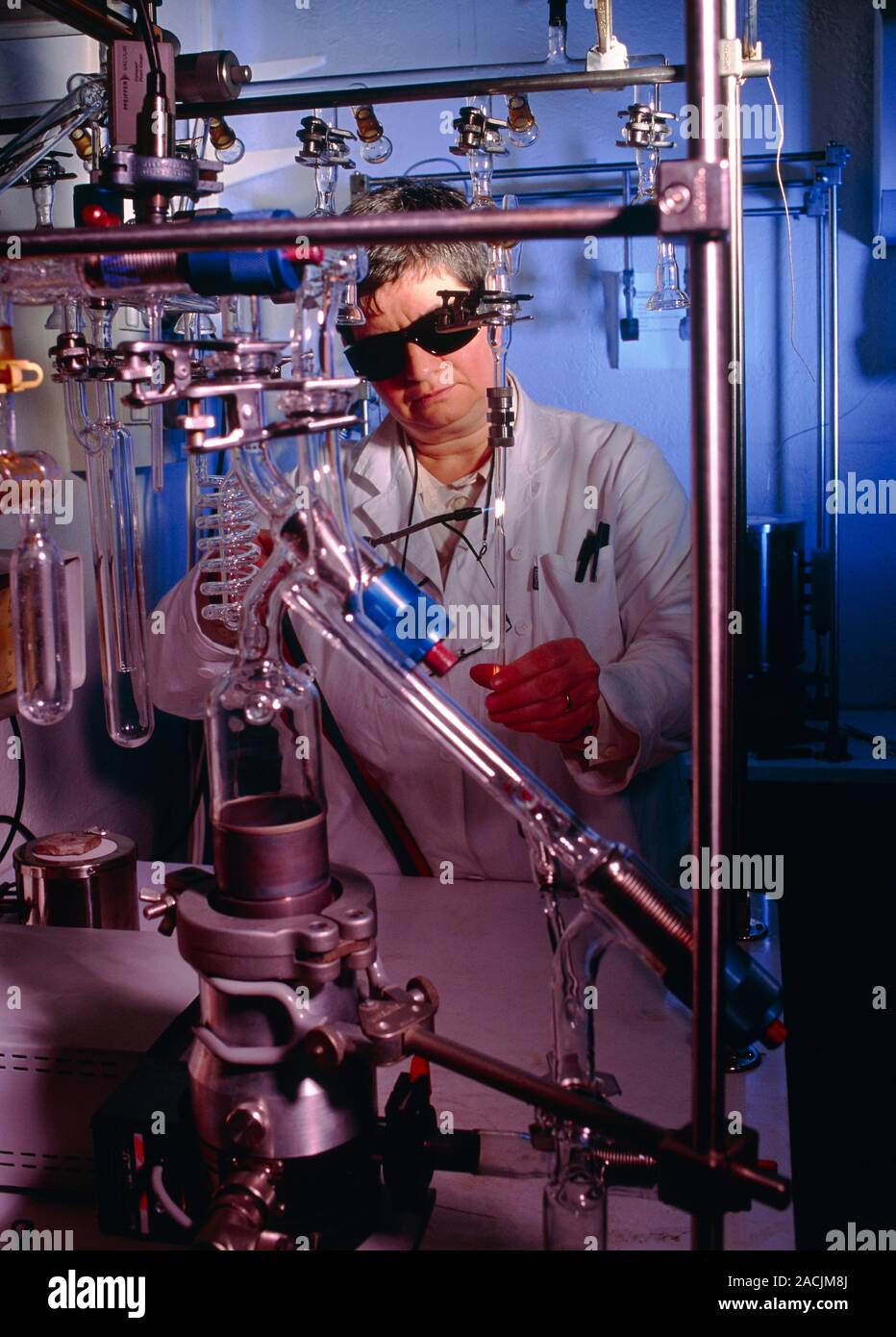 Accelerator mass spectrometry research. Researcher preparing a gas ...