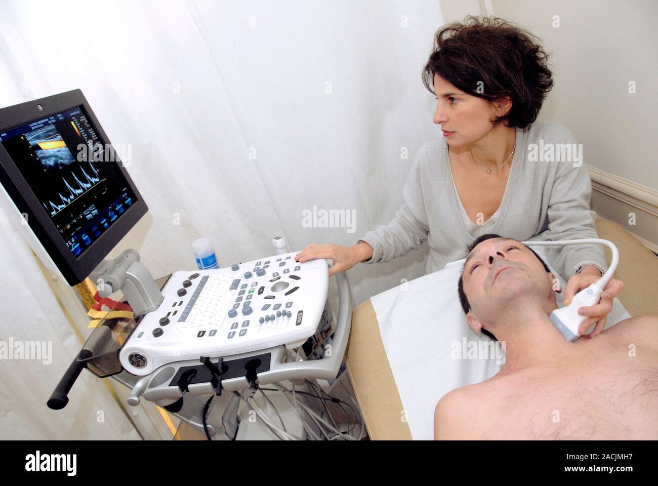 Doppler ultrasound scan of an artery in the neck of an adult male ...