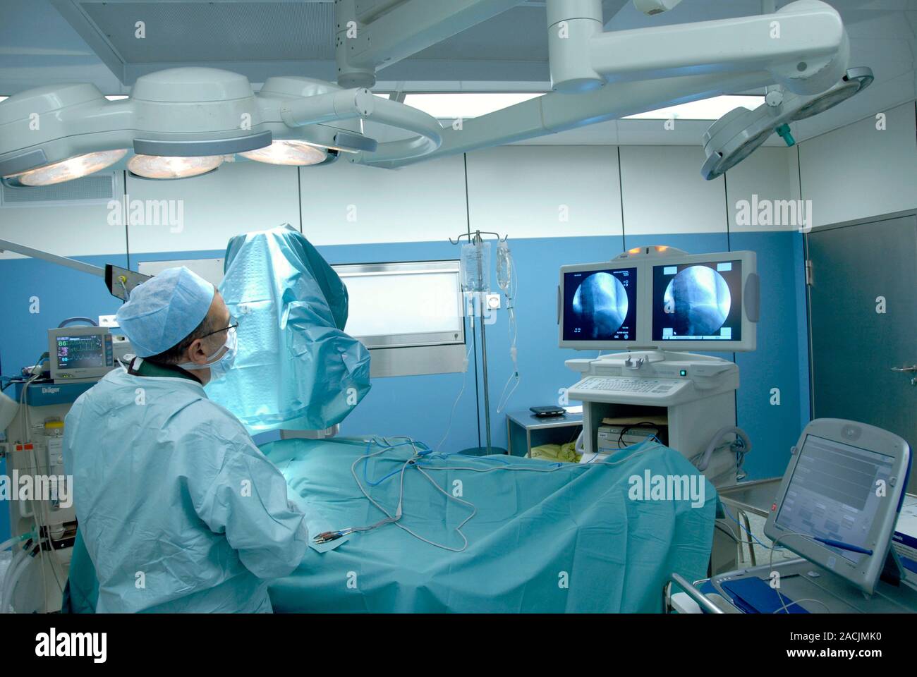 Cardiac surgeon in a hospital operating theatre conducts surgery on a ...