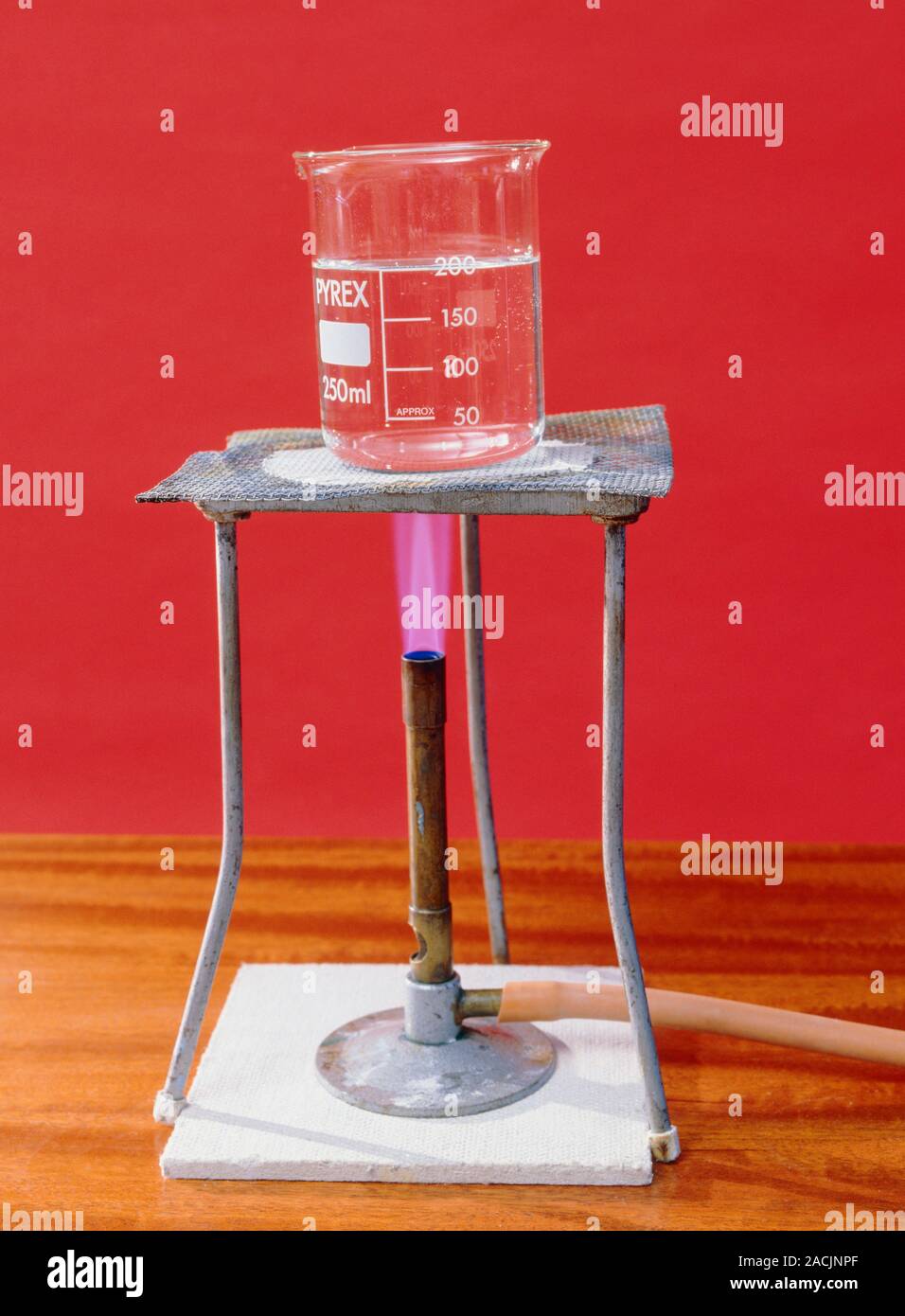 Water being heated. 200 millilitres of water being heated by a Bunsen ...