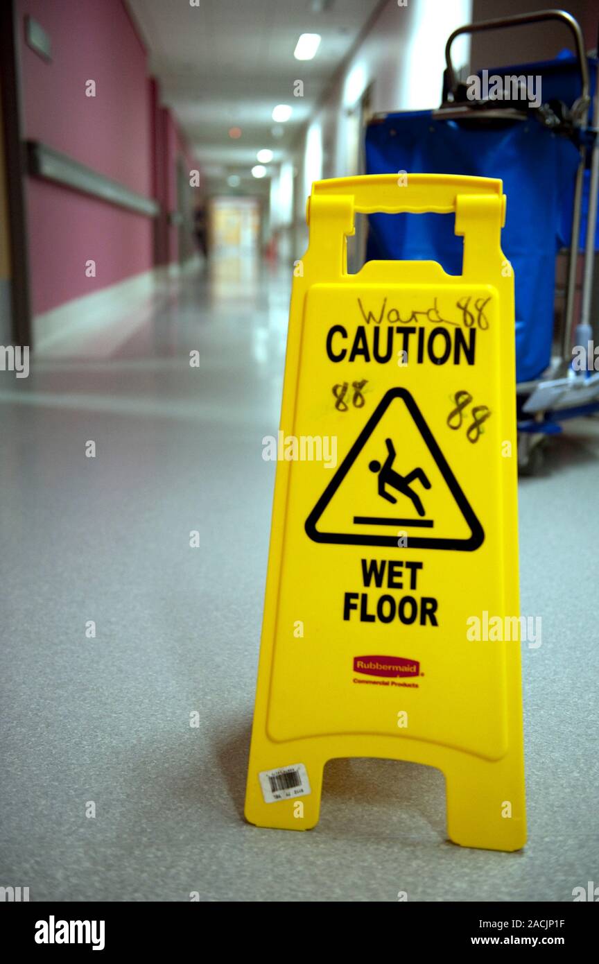 Slip hazard warning sign, in a hospital corridor Stock Photo - Alamy