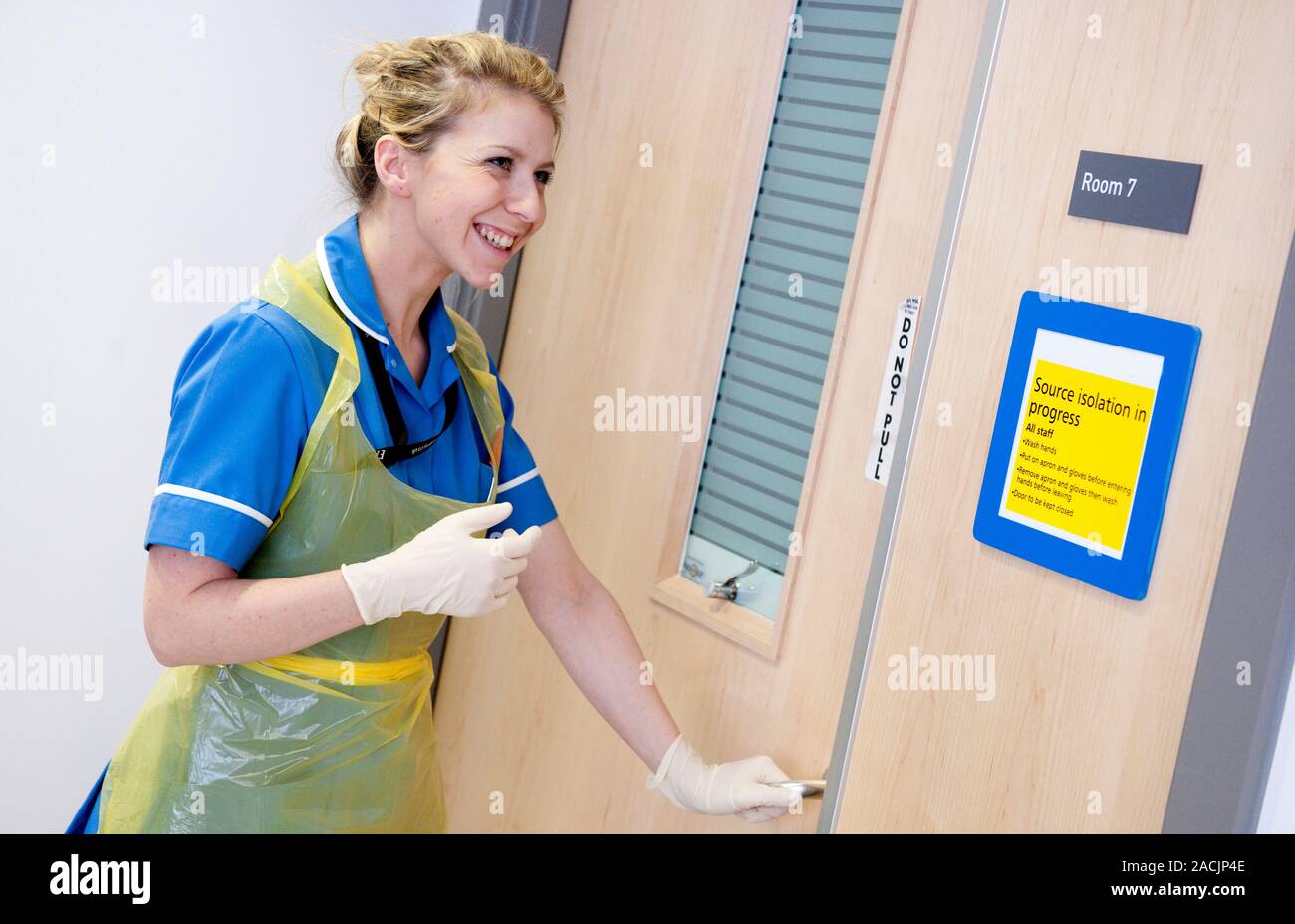 Infection control nursing. Nurse putting on latex gloves before ...