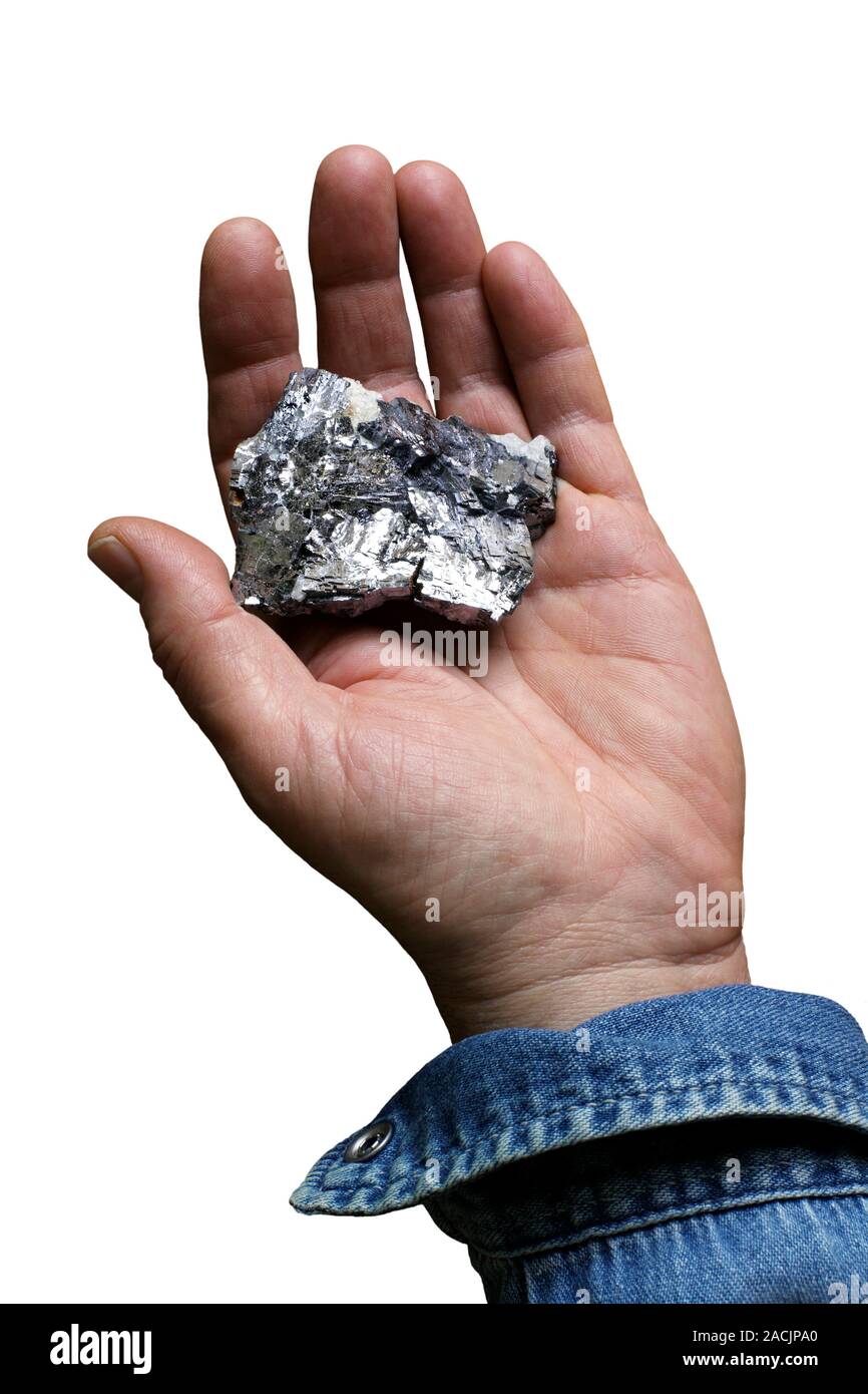 Sample of galena, held in a hand. Galena (lead sulphide, PbS) is a ...