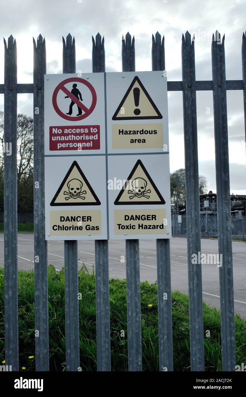 Warning signs outside industrial plant that handles dangerous and toxic ...