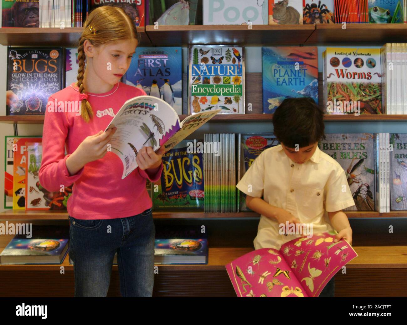 Children in a museum shop. Children reading books in a museum shop ...