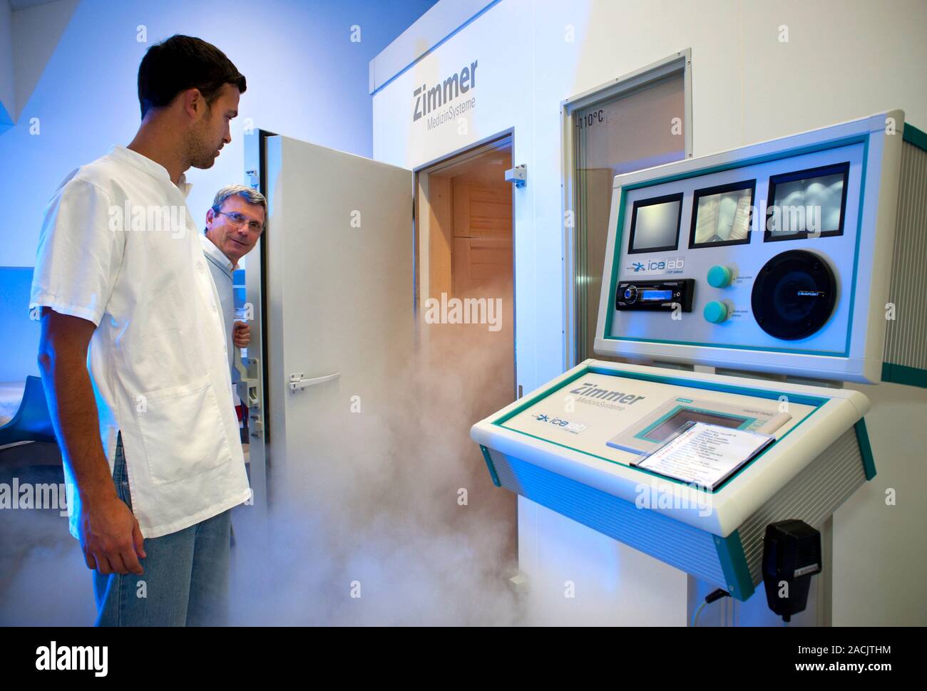 Cryogenic chamber therapy. Technicians outside an open cryotherapy ...
