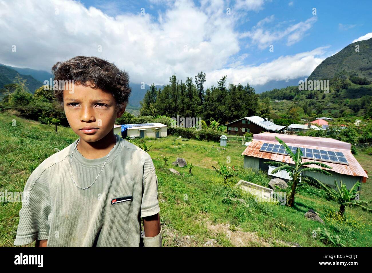 Solar panels. Boy standing in front of buildings with photovoltaic ...