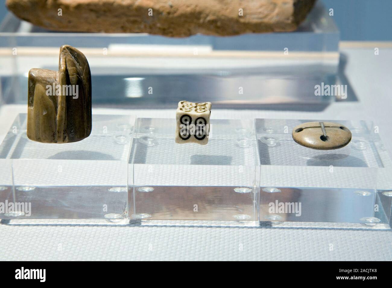 Ancient Greek artifacts. Ivory chess piece (left), bone die (centre ...