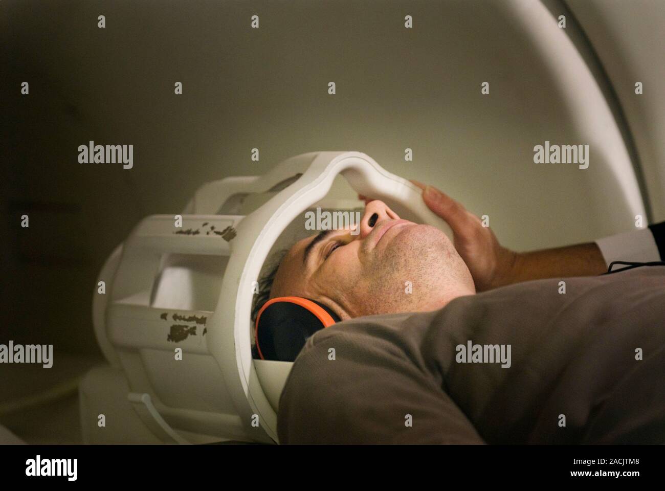 Autism research. Man with autism undergoing a functional magnetic ...
