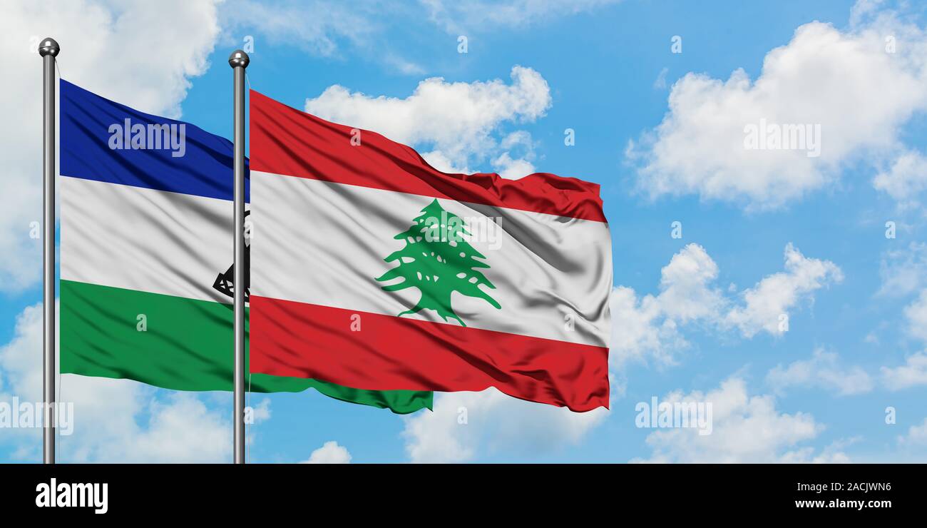 Lesotho and Lebanon flag waving in the wind against white cloudy blue ...