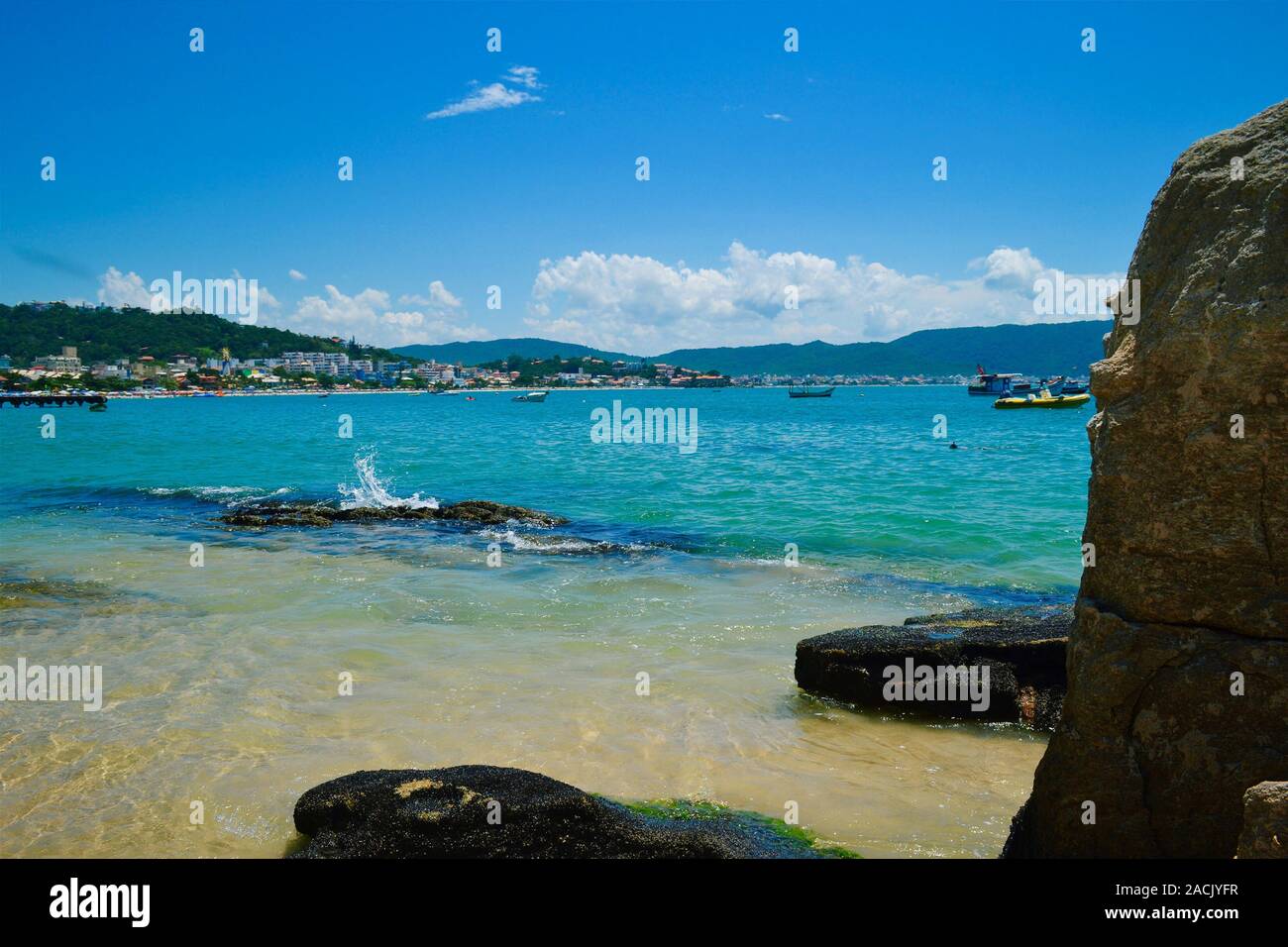 Crystal-clear waves crashing on rocks from a summer day at Bomba and ...
