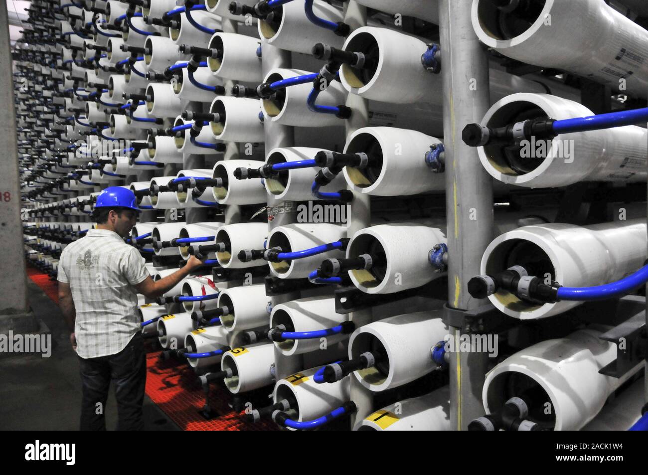 Desalination plant. Engineer inspects the Reverse Osmosis membrane ...