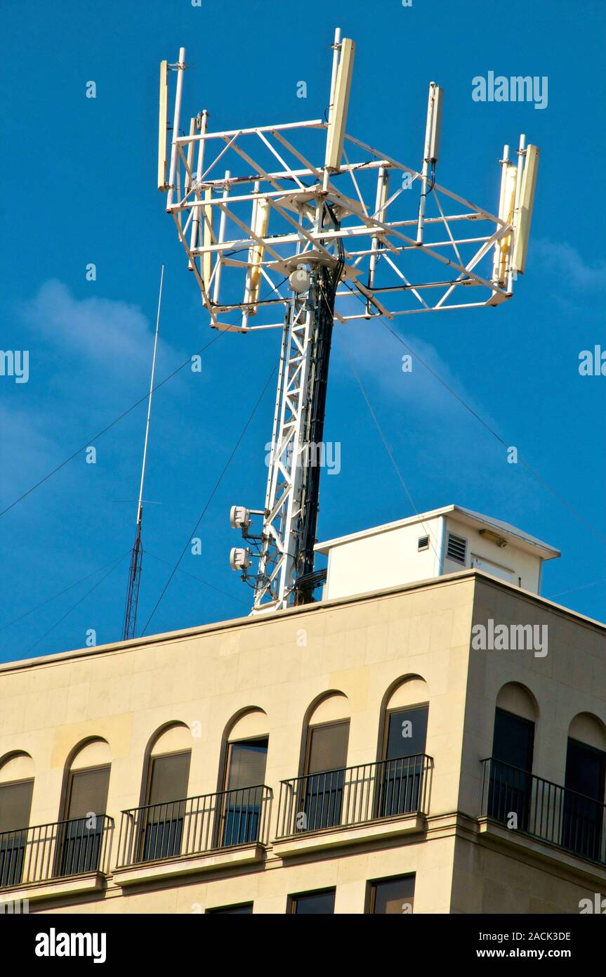 Mobile phone mast on a building. Mobile phone microwave signals are ...