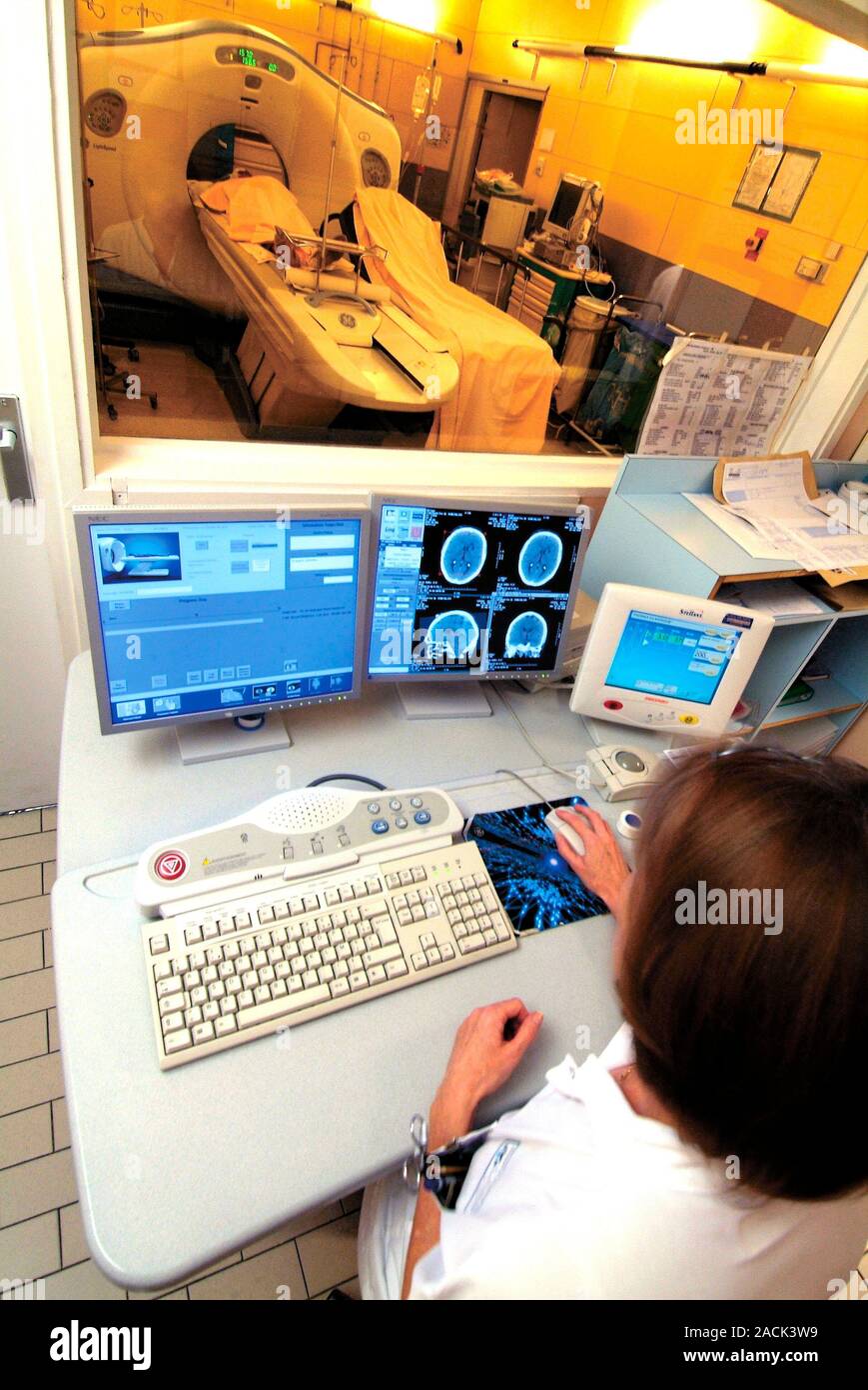 MRI scan. Radiographer operating an MRI (magnetic resonance imaging ...