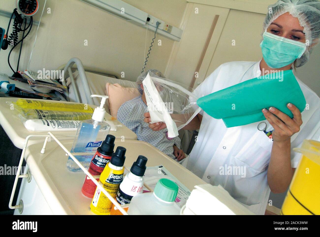 Infusion equipment. Nurse preparing the equipment being used to feed a ...