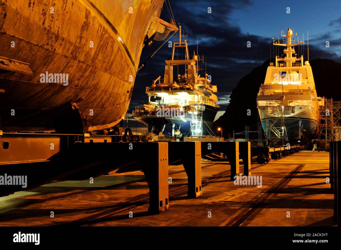 Luxury yacht shipyard. Luxury yachts undergoing maintenance at the ...